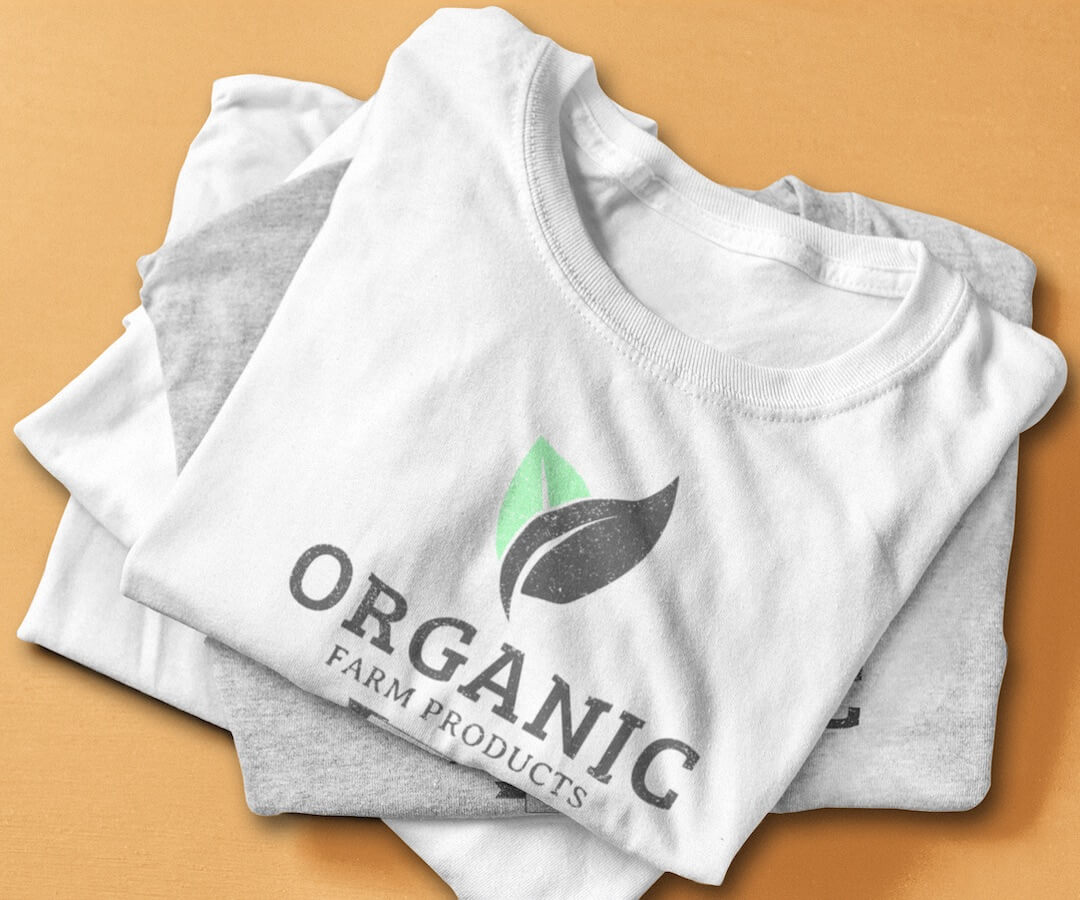 t-shirt-mockup-featuring-brand-and-a-stack-of-folded-t-shirts